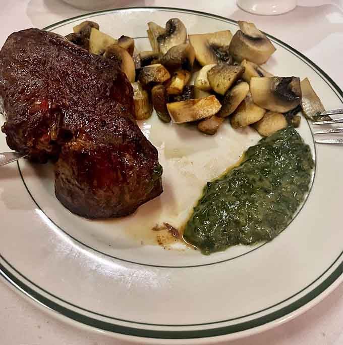 Filet mignon with saut&eacute;ed mushrooms and creamed spinach, tender enough to make you question every other steak you've ever eaten.