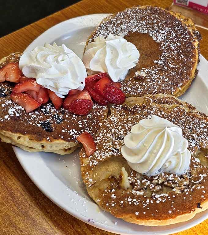 Powdered sugar, whipped cream, fresh strawberries: this plate proves breakfast can absolutely be an art form.