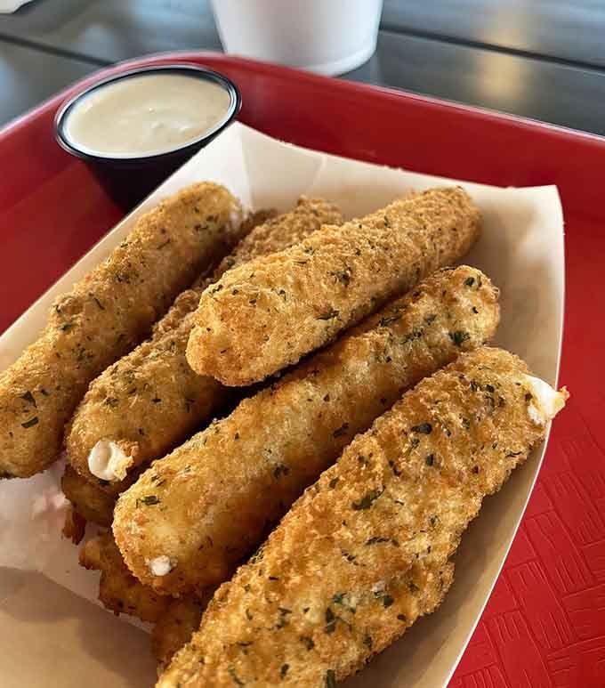 Breaded cheese sticks with that perfect golden crust and creamy dipping sauce are basically edible happiness on a plate.