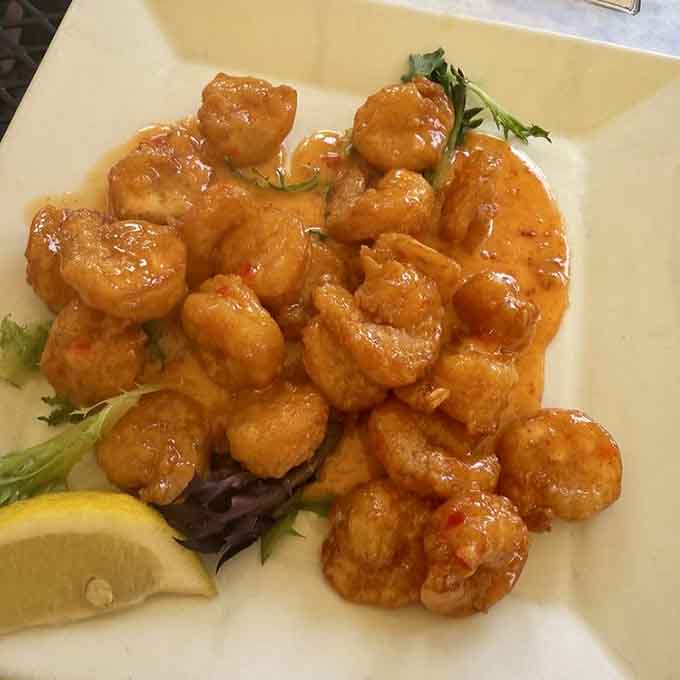 Bang bang shrimp glistens with that addictive sweet-spicy glaze that'll have you licking your fingers when nobody's watching.
