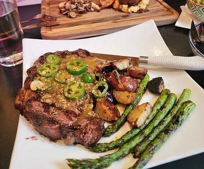 That ribeye comes with asparagus and roasted potatoes, proving vegetables can be just as exciting as the main event.