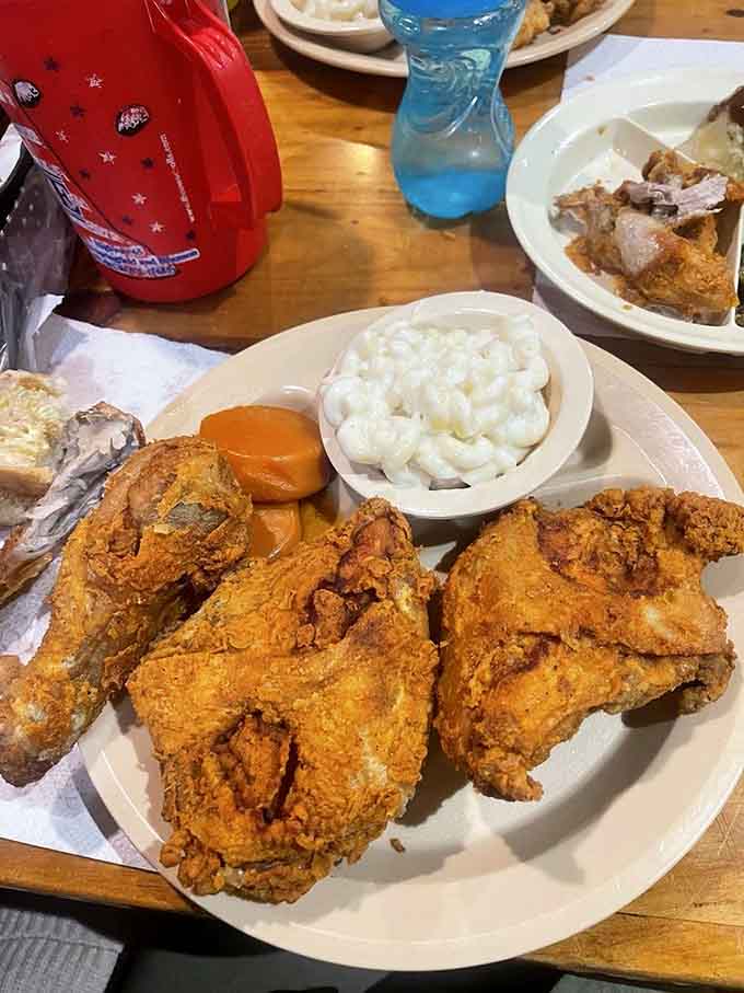 Fried chicken so gloriously crispy it practically crackles, surrounded by enough sides to feed your entire bowling league after tournament night.
