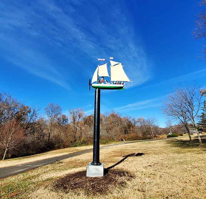 A miniature sailing ship perched on a pole, forever searching for an ocean that doesn't exist in landlocked Missouri.