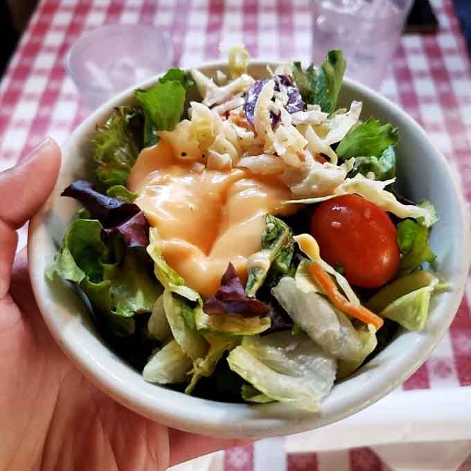 Fresh, crisp salad that actually looks appetizing, proving they care about every component of your meal, not just the star.
