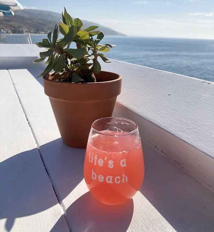 Life really is a beach when your watermelon mimosa sparkles in the sunshine beside ocean views.