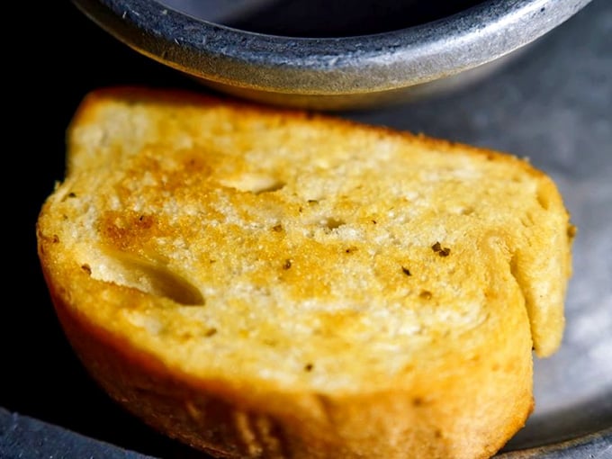 Garlic bread toasted to perfection, because even medieval banquets understood the universal language of carbs and butter.
