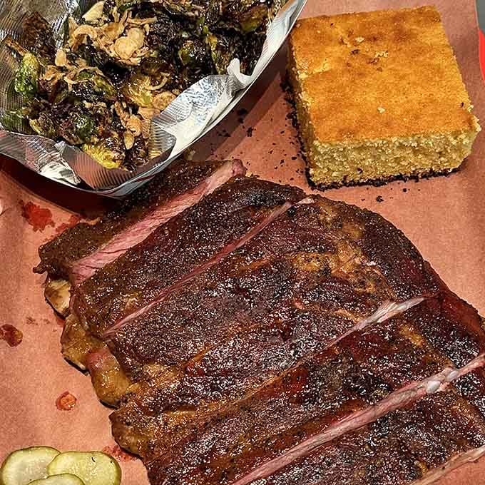 Ribs, cornbread, and collards create the holy trinity of barbecue bliss on one perfectly composed plate of happiness.