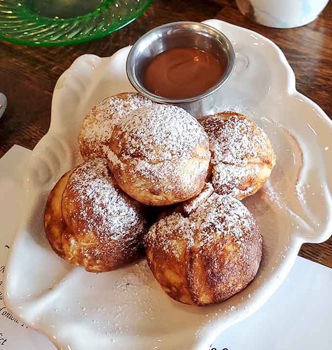 Those powdered sugar-dusted spheres of joy are Danish aebleskivers, and yes, they taste exactly as wonderful as they look.