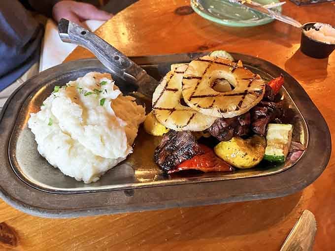 Grilled pineapple crowning a sizzling steak platter brings tropical vibes to the northwoods, like a luau crashed a supper club.