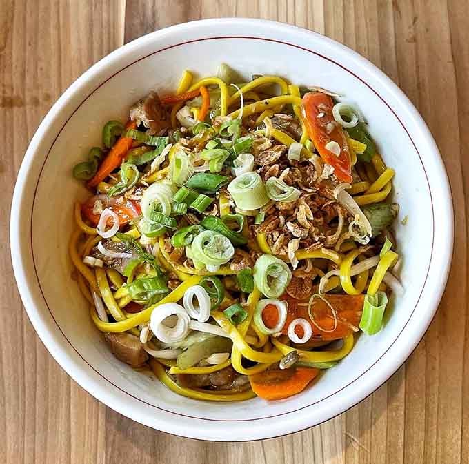 Yolo mein lives up to its name with colorful vegetables dancing across thick noodles worth living for.