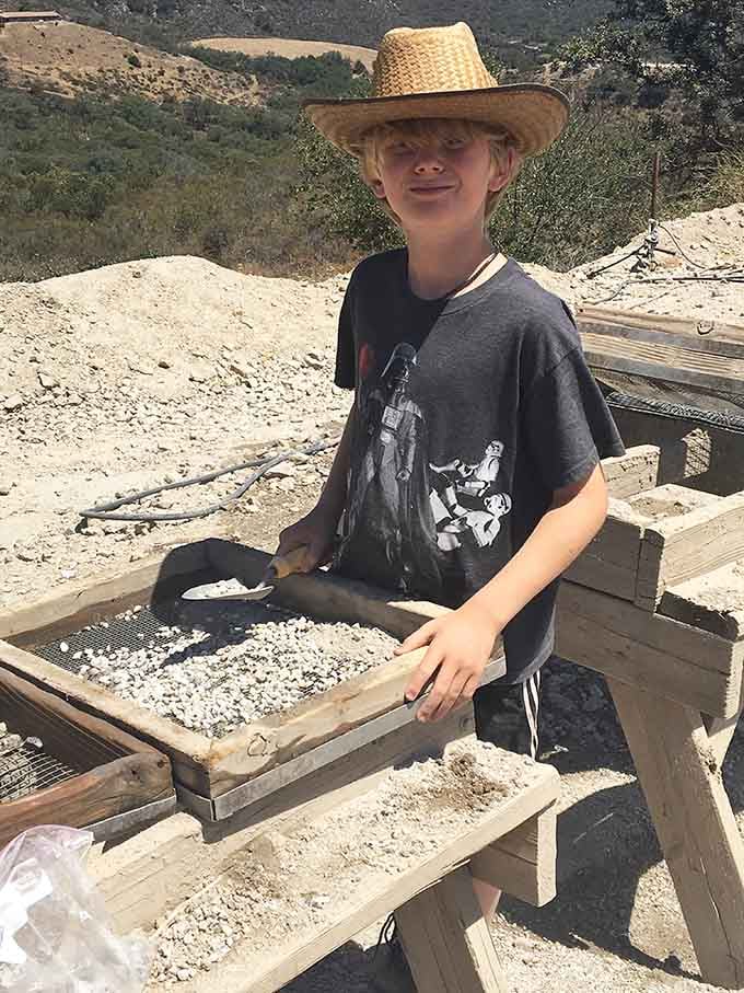 That young prospector's smile says he's found something special, or at least he's having the time of his life.