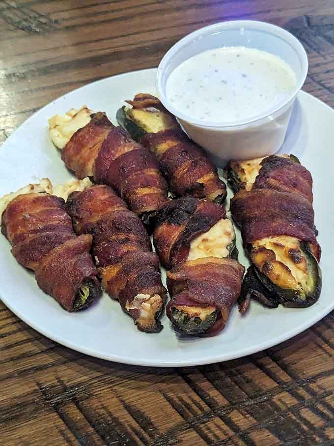 Bacon-wrapped jalape&ntilde;os stuffed with cheese are basically little flavor bombs wrapped in crispy heaven with a ranch parachute.