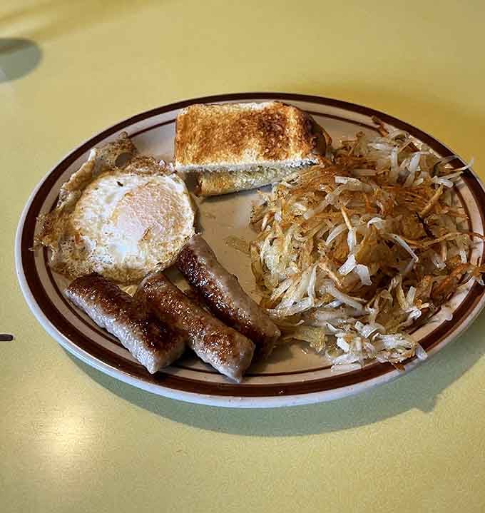 Breakfast done right: eggs, sausage, hash browns, and toast to fuel your mountain exploration ahead.