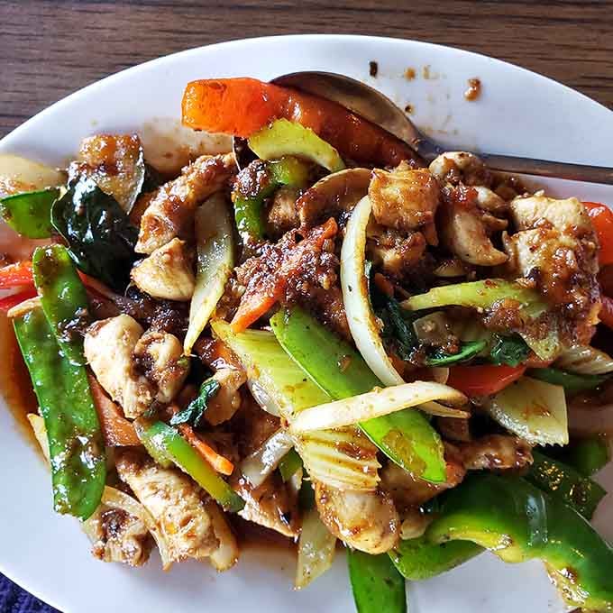 Thai basil chicken loaded with vegetables and aromatic herbs brings serious flavor to your table between the train windows.