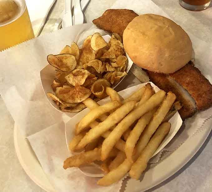 That fish is staging a full rebellion against the bun, supported by crispy chips that know their supporting role.