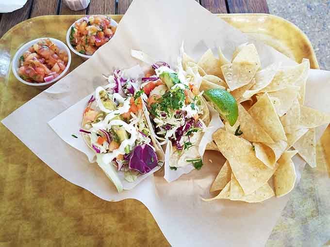 Fresh cabbage, pico de gallo, and perfectly grilled fish create magic in every single bite here.