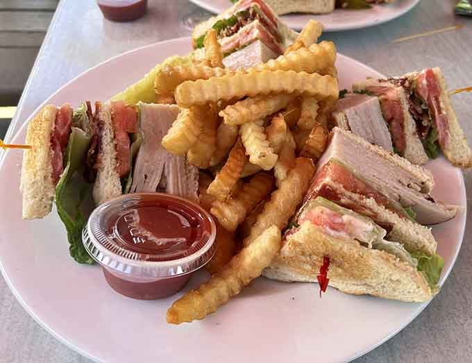 This triple-decker turkey club with waffle fries is basically an edible engineering marvel that tastes as good as it looks.