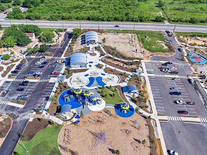 From above, the park's layout reveals thoughtful planning: playgrounds, parking, and green space working in perfect harmony.
