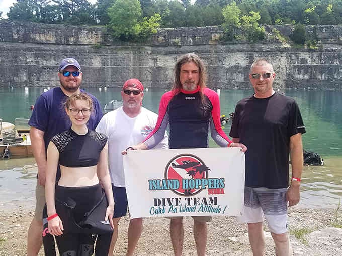 A dive team posing proudly because they just discovered Kentucky's best-kept aquatic secret in their own backyard.