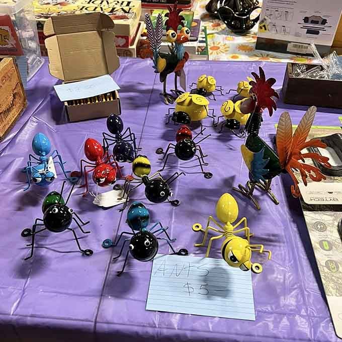 Handcrafted metal ants marching across a purple tablecloth, because your garden absolutely needs a whimsical insect invasion this summer.