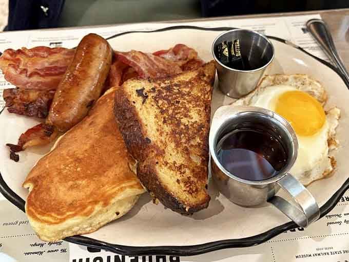 French toast, bacon, sausage, and eggs with twin syrup pitchers, this plate channels every great diner memory you've ever had.
