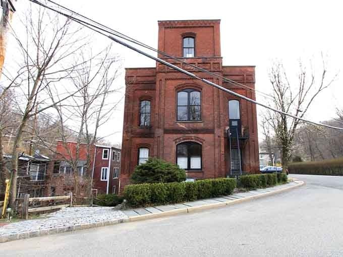 That red brick building has seen more history than most museums, standing proud through changing times.