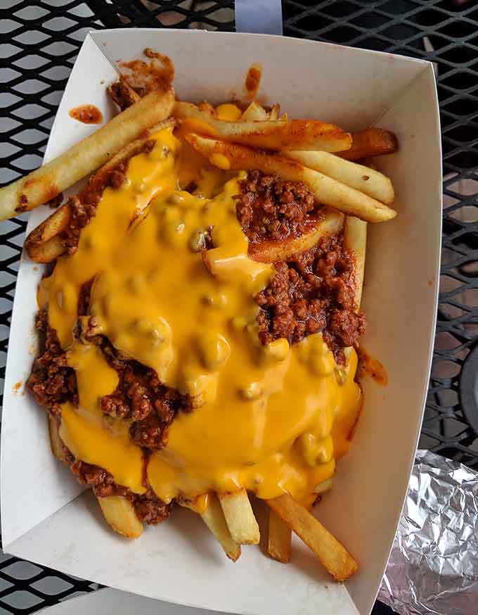 Chili and cheese cascading over crispy fries like a golden, meaty waterfall of pure comfort food happiness.