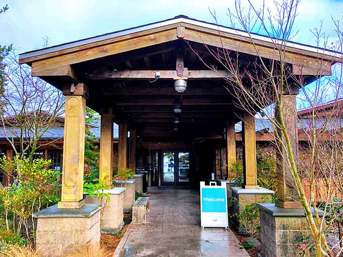 Carved wooden pillars frame the library entrance, inviting book lovers into a space that honors both heritage and learning.