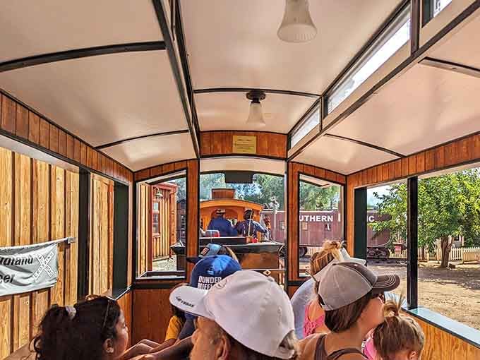 The enclosed passenger car offers a more refined ride, complete with wooden benches and old-world charm.