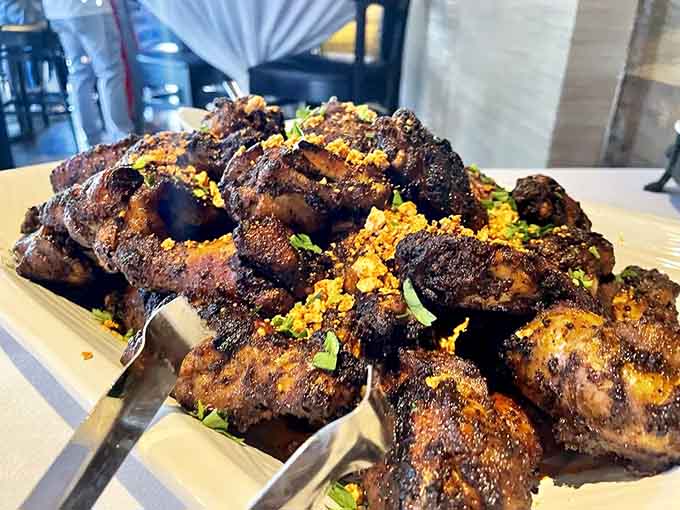 Wings with char marks that tell stories of open flames and bold flavors worth getting your hands messy for.