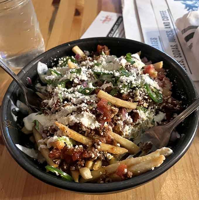 Bison chili cheese fries bring comfort food to new heights, perfect fuel for your competitive endeavors.