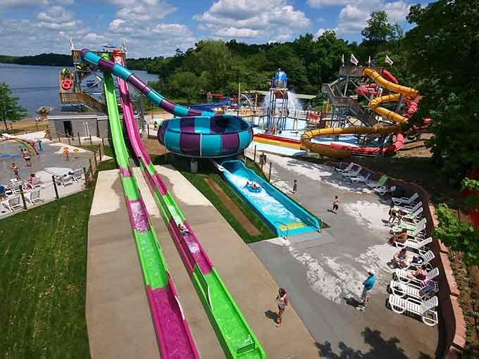 The waterpark sprawls along the lake like a colorful aquatic wonderland designed by someone who really understands summer.