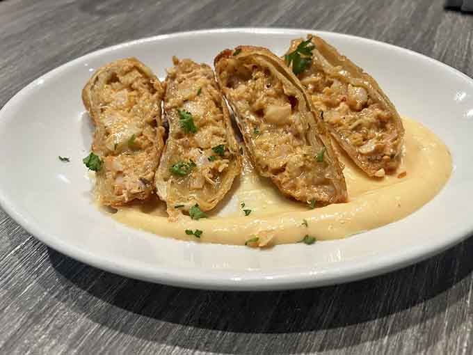 Seafood eggrolls swimming in creamy sauce represent fusion cooking at its most delicious and unapologetic best.