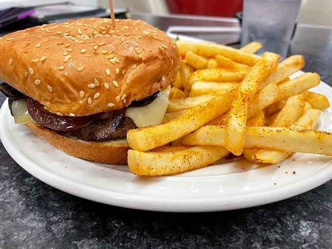 A juicy burger topped with mushrooms and Swiss on a sesame bun is pure diner perfection in every bite.