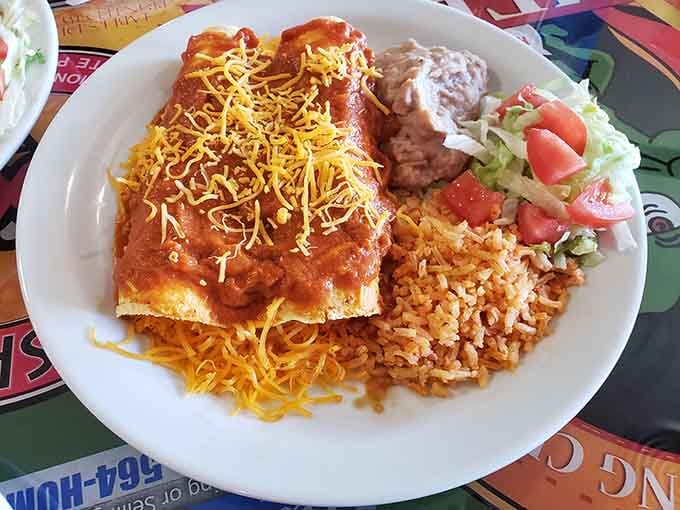 Enchiladas Tejanas arrive blanketed in red sauce and cheese, proving Texas knows a thing or two about comfort.