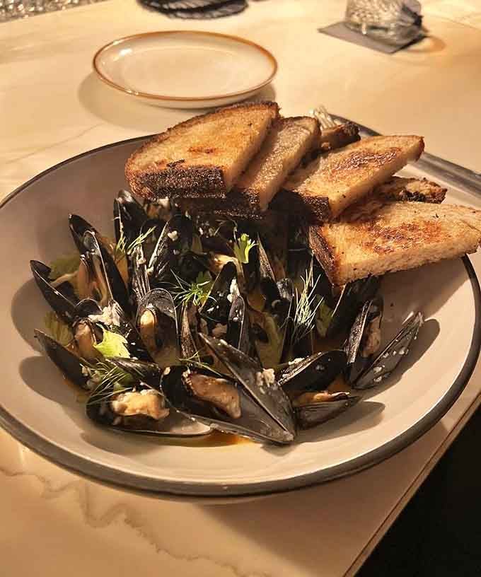 Mussels nestled with grilled bread, bringing coastal vibes to the landlocked Southwest with delicious authority.