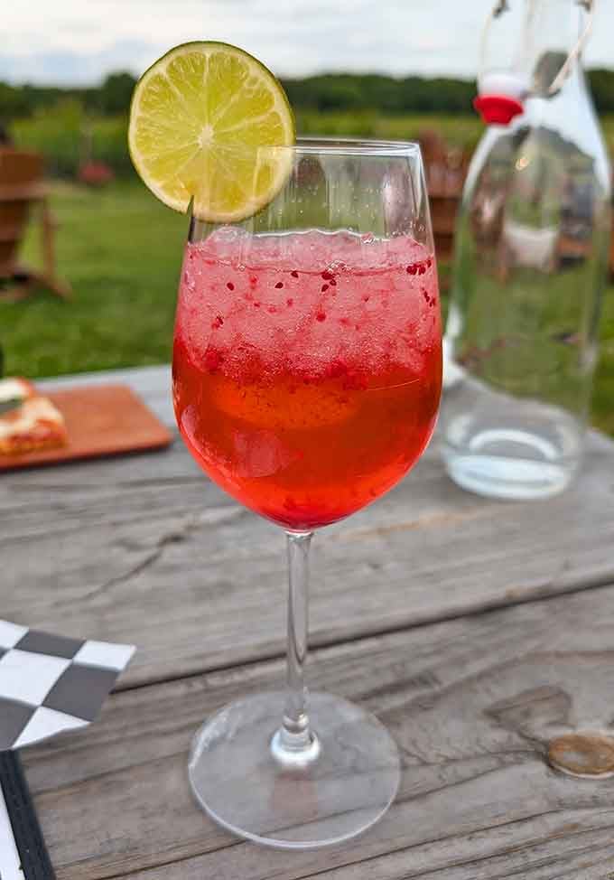 That ruby-red sangria with a lime garnish is basically summer in a glass, even when it's not technically summer outside.