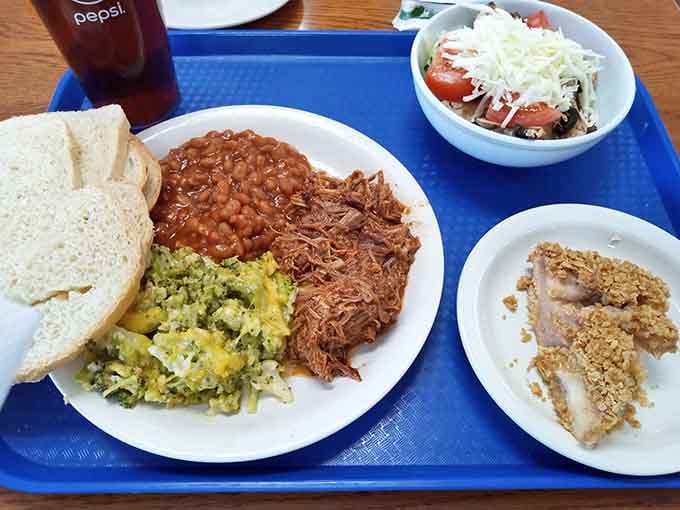 Pulled pork, beans, broccoli casserole, and white bread make a plate that understands what Midwestern hearts crave.