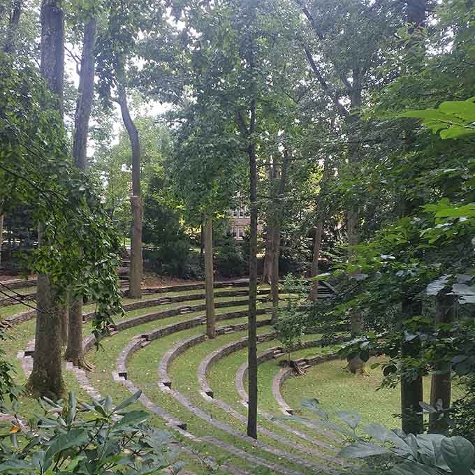 This hidden amphitheater nestled in the trees feels like stumbling upon a secret Shakespeare performance waiting to happen.