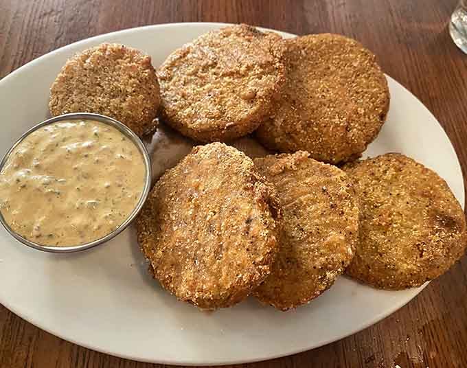 Cornmeal-crusted fried green tomatoes with creamy sauce, bringing Southern charm to the Pacific Northwest one bite at a time.