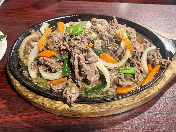 Sizzling bulgogi on a hot plate: the sound, the smell, the steam rising like culinary theater at your table.