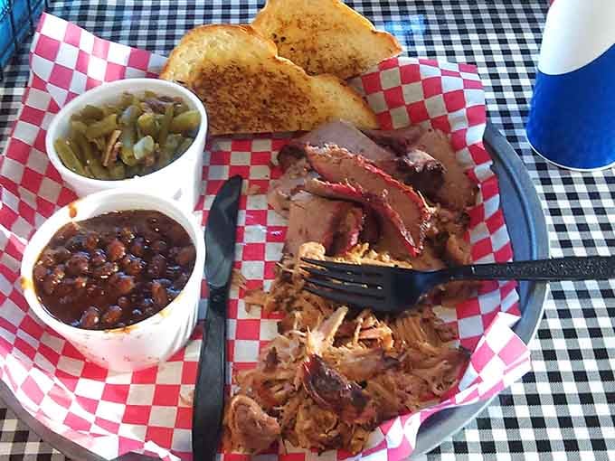 Pulled pork and brisket share the plate with beans and toast in true barbecue harmony.