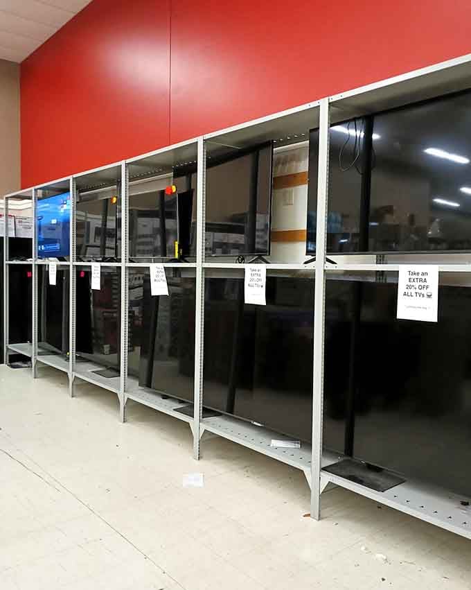 Rows of televisions standing at attention like electronic soldiers, waiting to upgrade someone's binge-watching experience without the sticker shock.