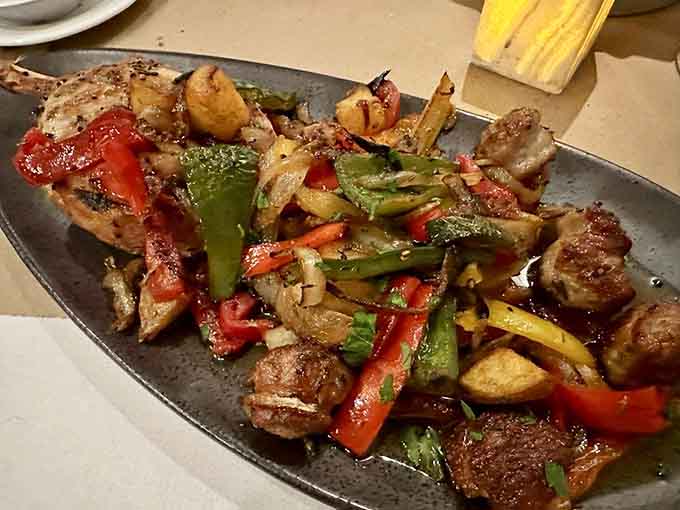 Pork chop country style arrives sizzling with peppers and onions, making vegetarians question their life choices for just a moment.