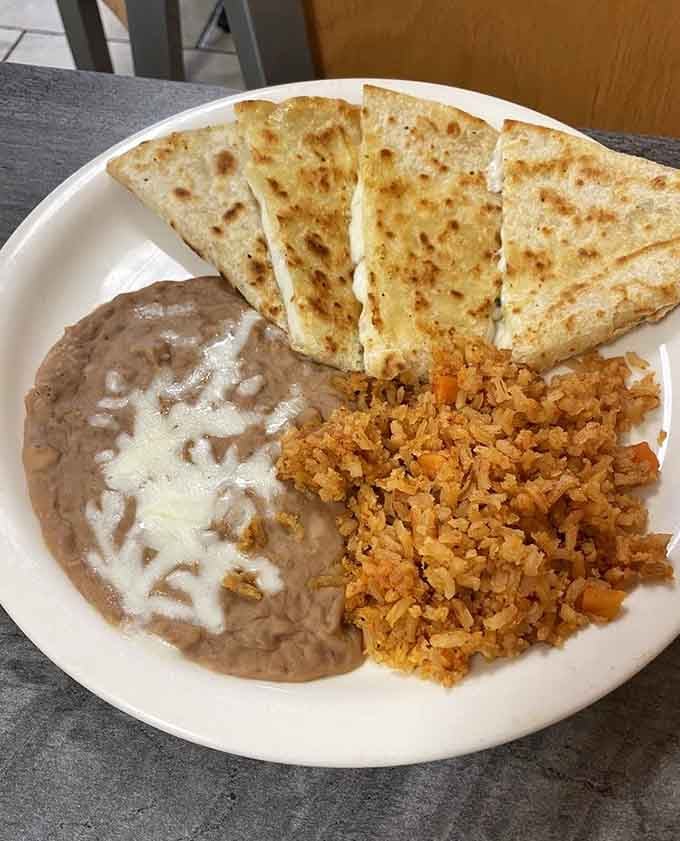 Golden quesadilla triangles paired with rice and beans, because sometimes simple combinations create the most satisfying meals possible.