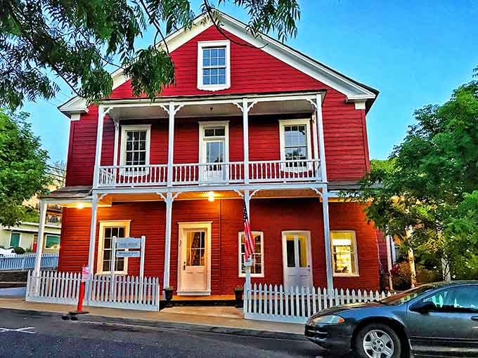 The Sugg House glows red against the evening sky, a Victorian beauty that's been turning heads for generations.