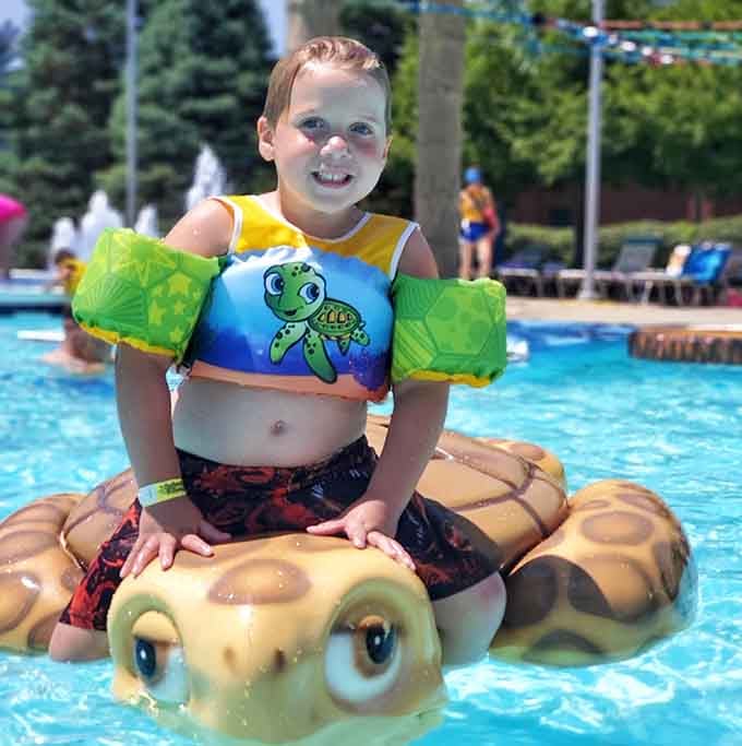 Nothing says summer like a kid grinning from ear to ear while riding an inflatable turtle friend.