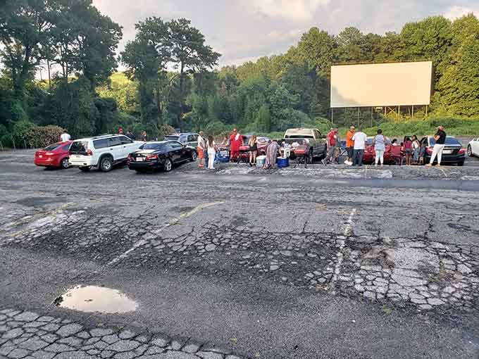 Families stake their claims early, turning parking spots into personalized viewing lounges before the opening credits roll.
