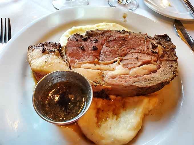 Prime rib carved thick and cooked precisely, proving this kitchen handles beef as expertly as it does the ocean's bounty.