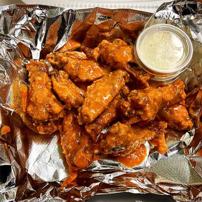 These wings are proof that sometimes the best things in life come glazed, sauced, and piled high on foil.